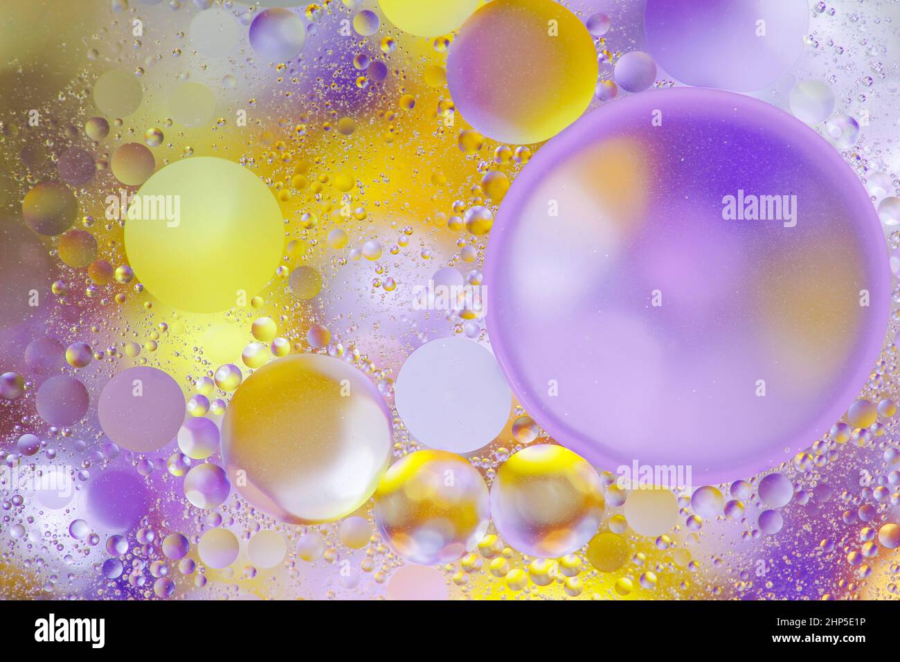 Abstract background with glossy and matte bubbles in yellow and purple ...