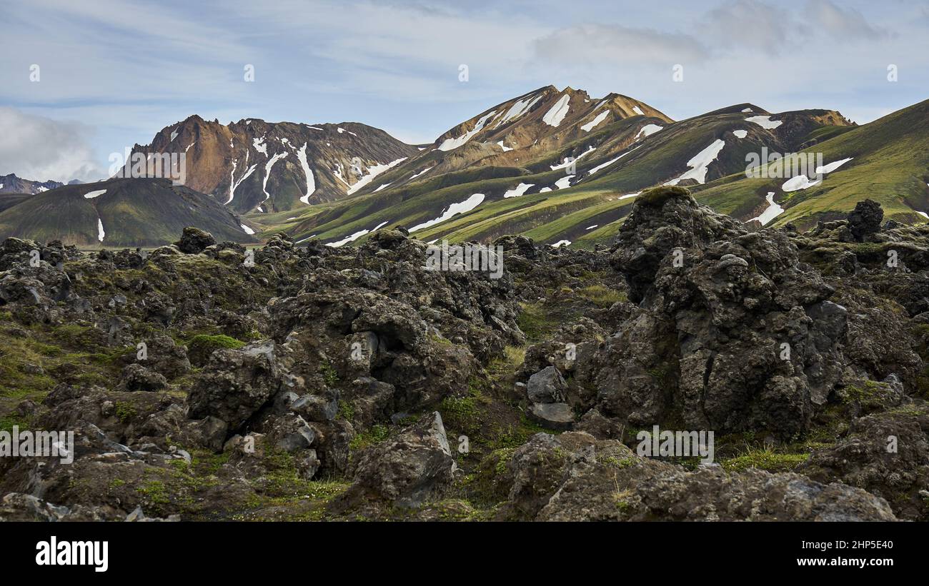 Mesmerizing view of green mountains with snow in Iceland Stock Photo ...