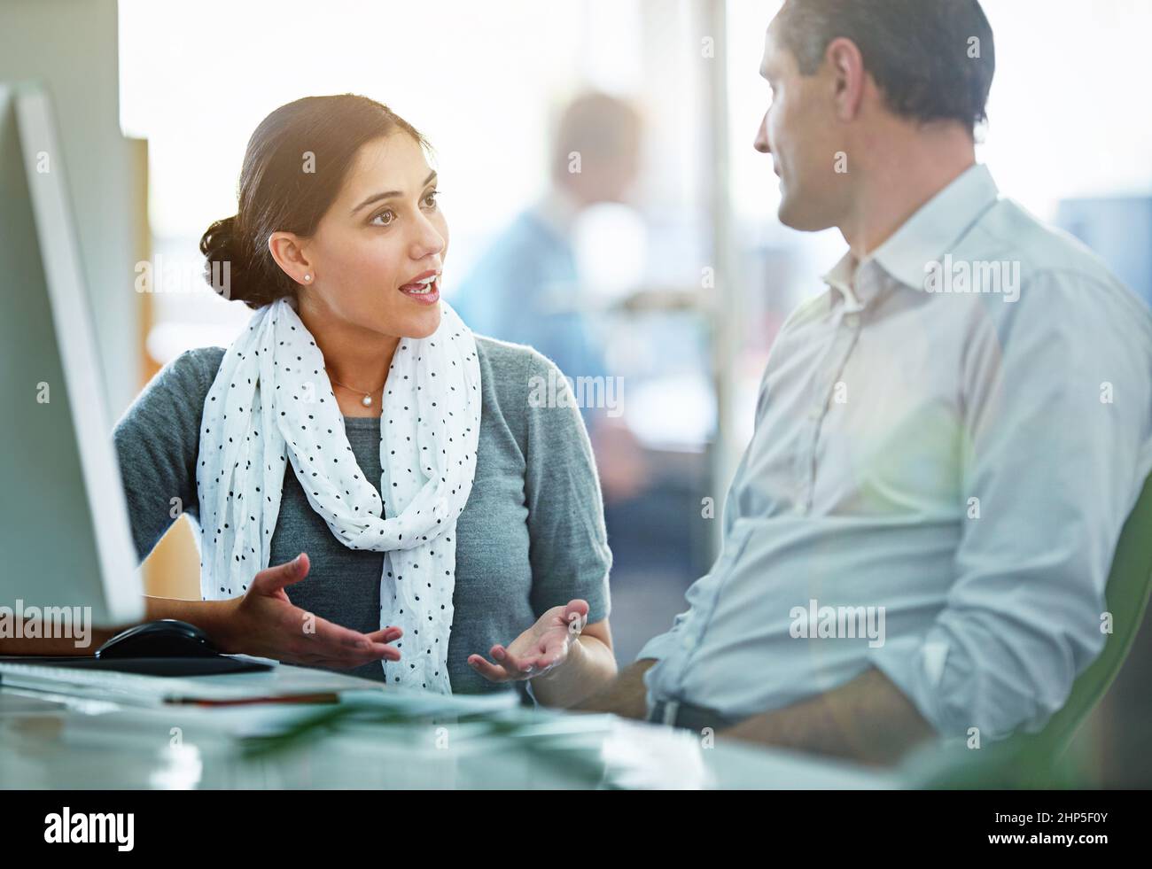 Sharing their creativity. Shot of designers talking together at a ...