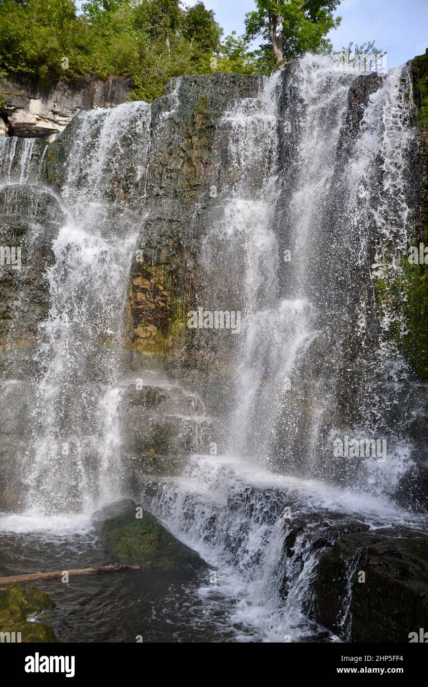 Water flowing over escarpment at Inglis Falls during Summer Stock Photo ...