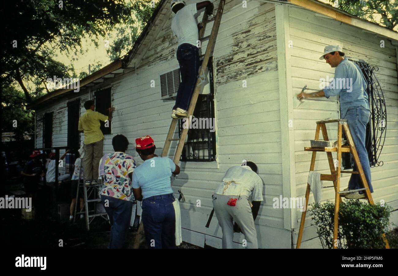 San Antonio Texas USA, 1992: Volunteers help paint a low-income ...