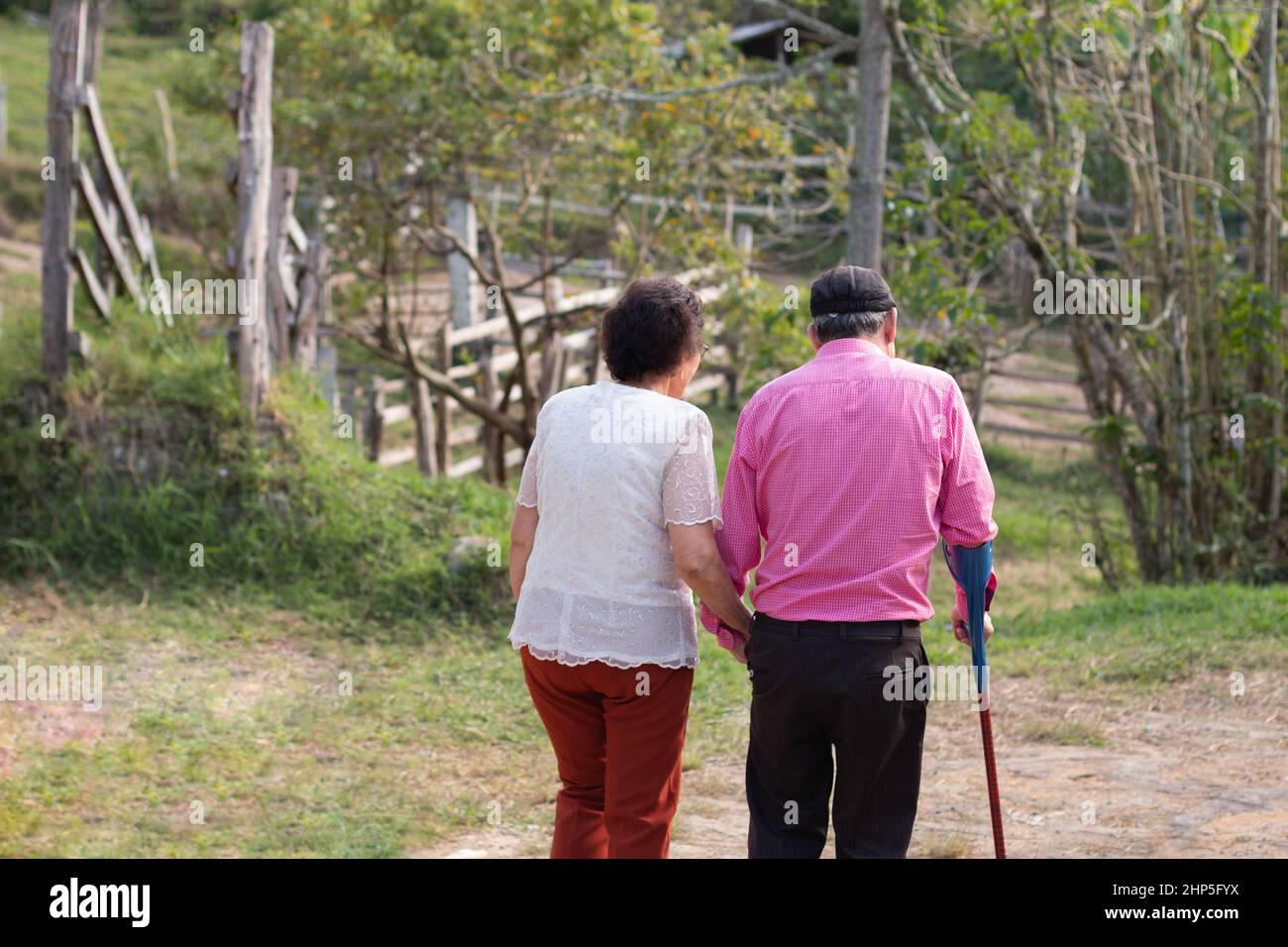 Elderly couple walking hand in hand. Two elderly people taking a walk ...