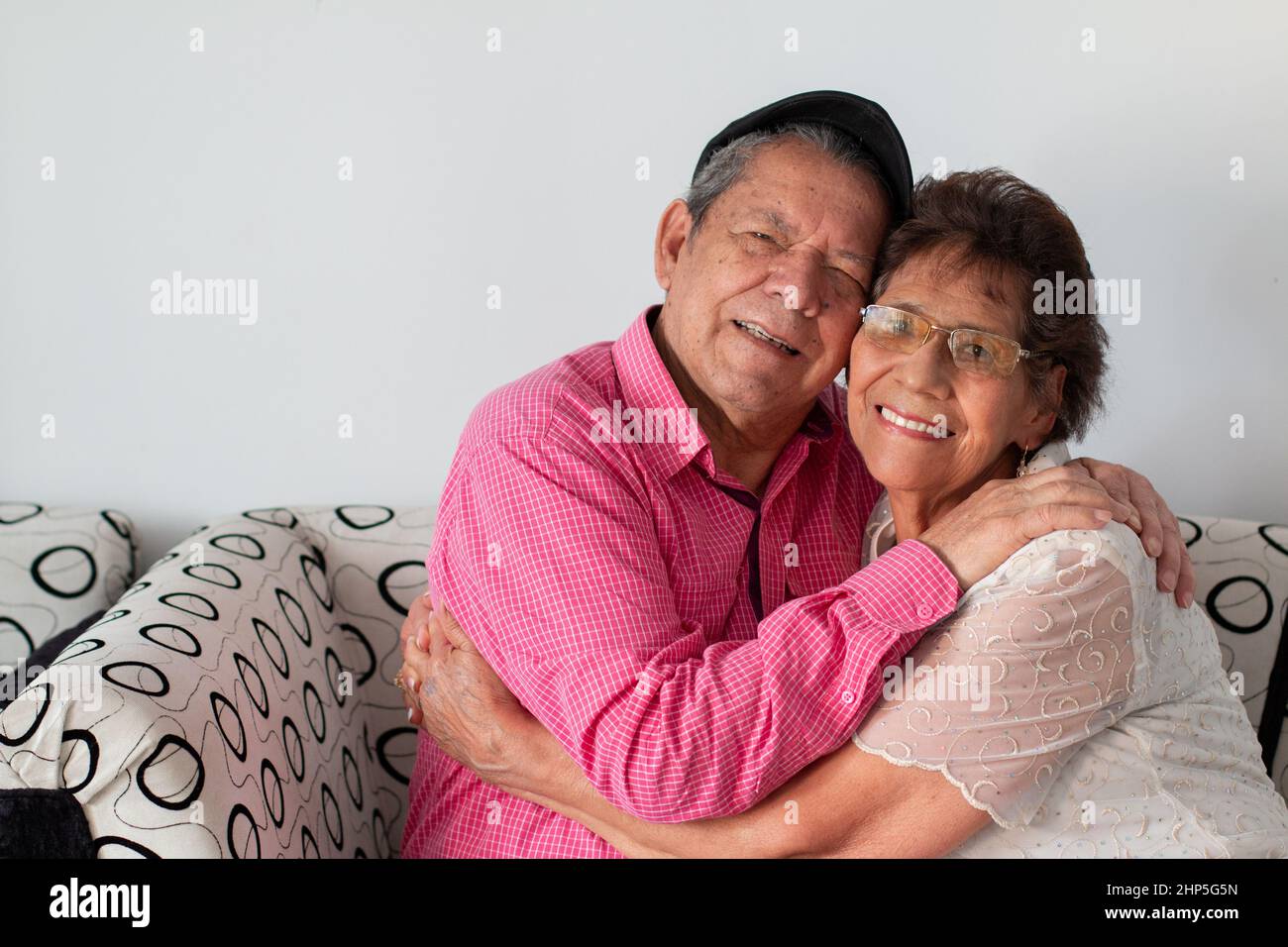 Elderly couple hugging and looking at the camera. Portrait of two very ...