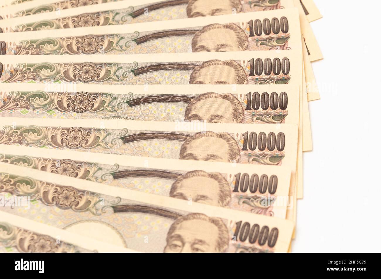 10,000 yen stack close up isolated on white background Stock Photo - Alamy