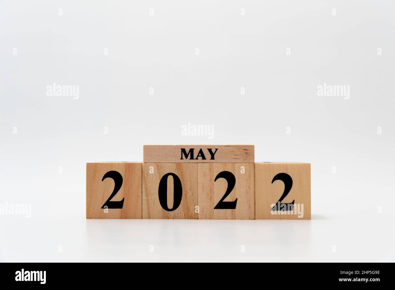 May 2022 written on wooden blocks isolated on white background with ...