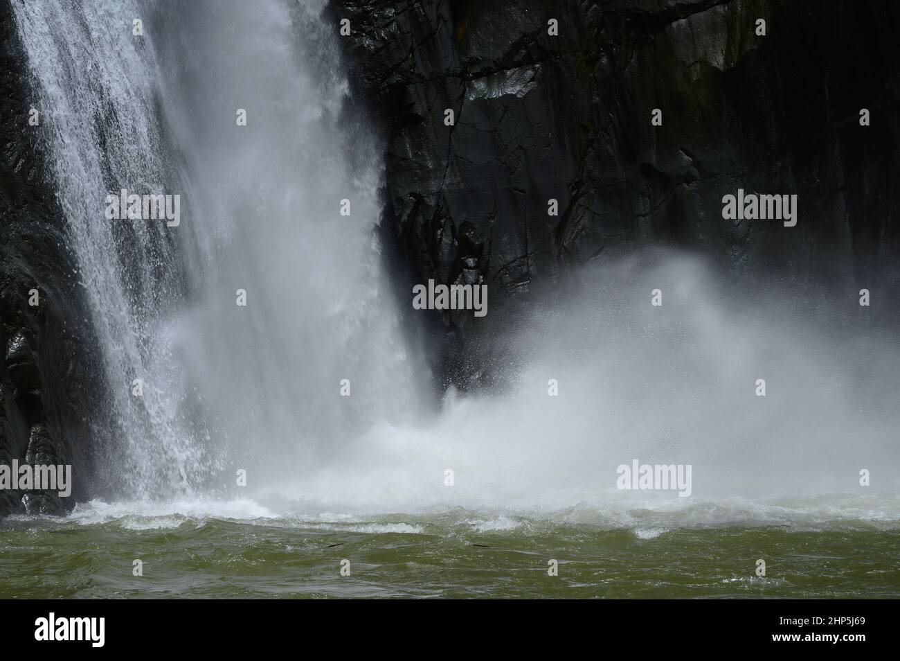 The photo shows a huge waterfall. Below is a perfectly clear water ...