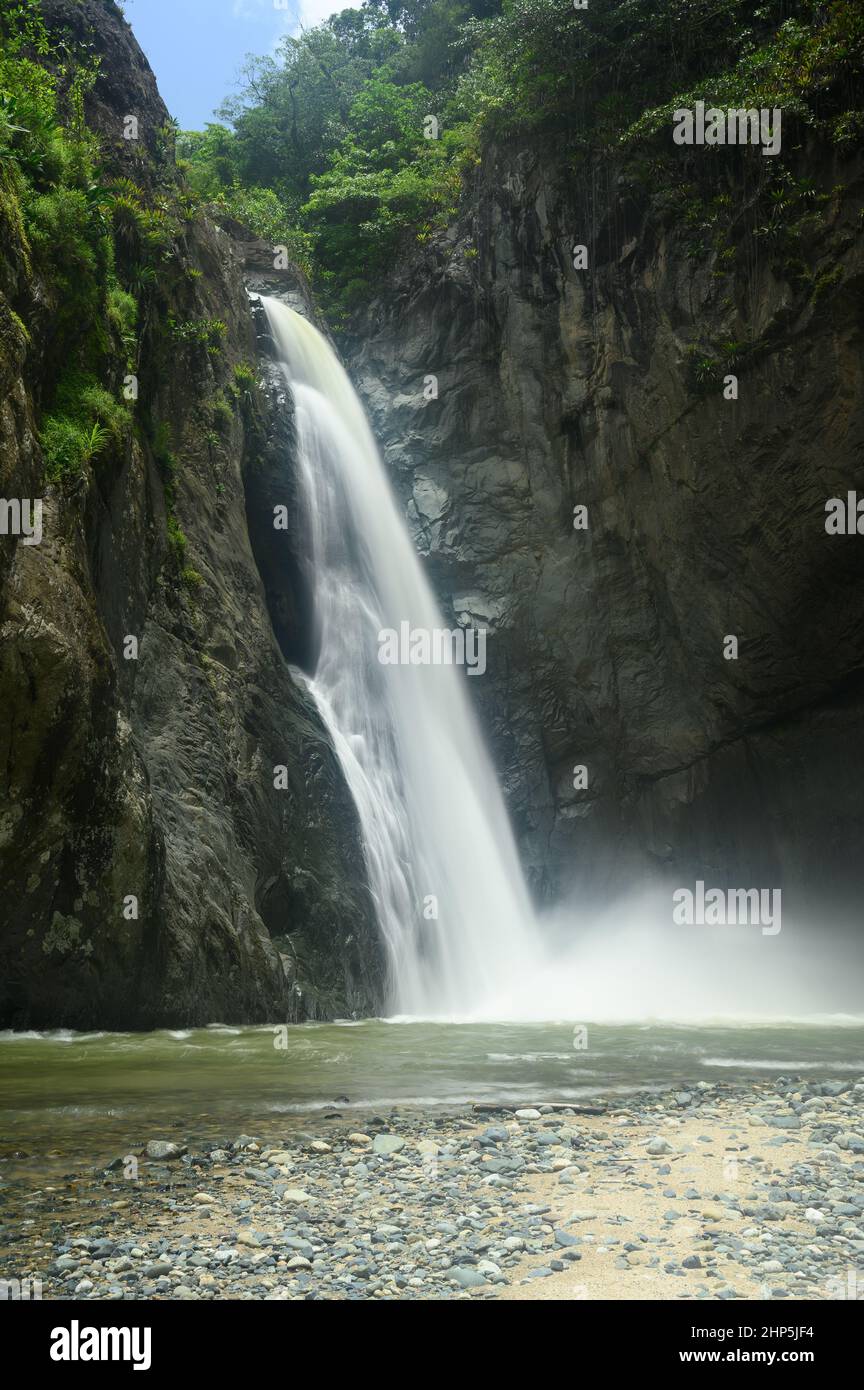 The photo shows a huge waterfall. Below is a perfectly clear water ...