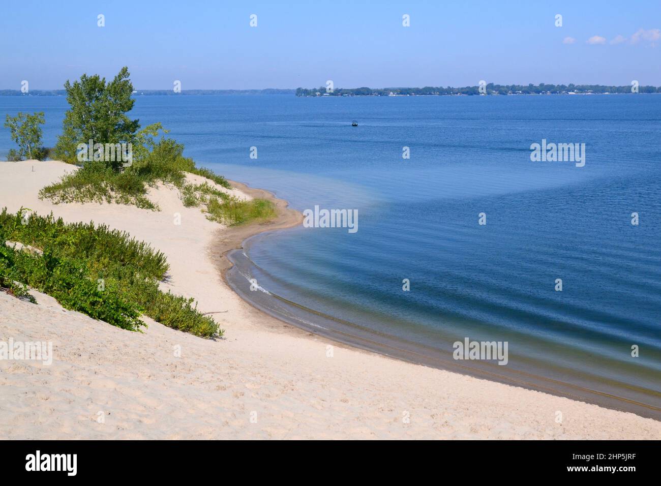 Sand dunes meeting blue water of Lake Ontario in Prince Edward County ...