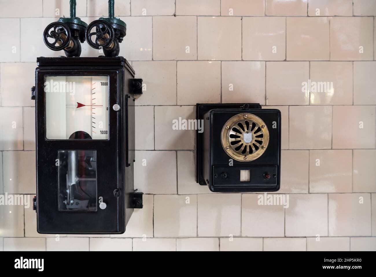 Two vintage wall-mounted industrial measurement and control instruments ...