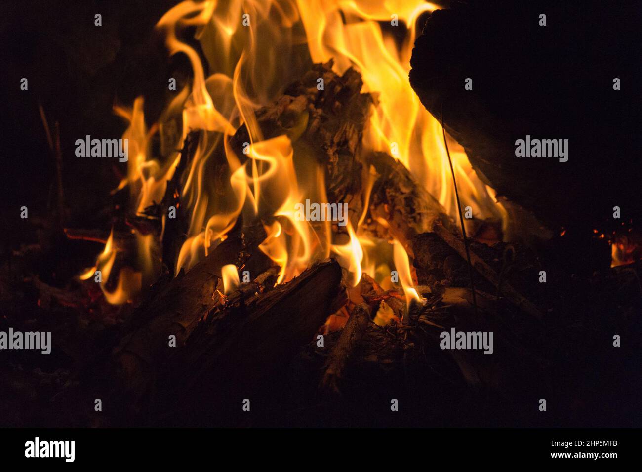 The view of bright flames and fire blazing at night on black background ...
