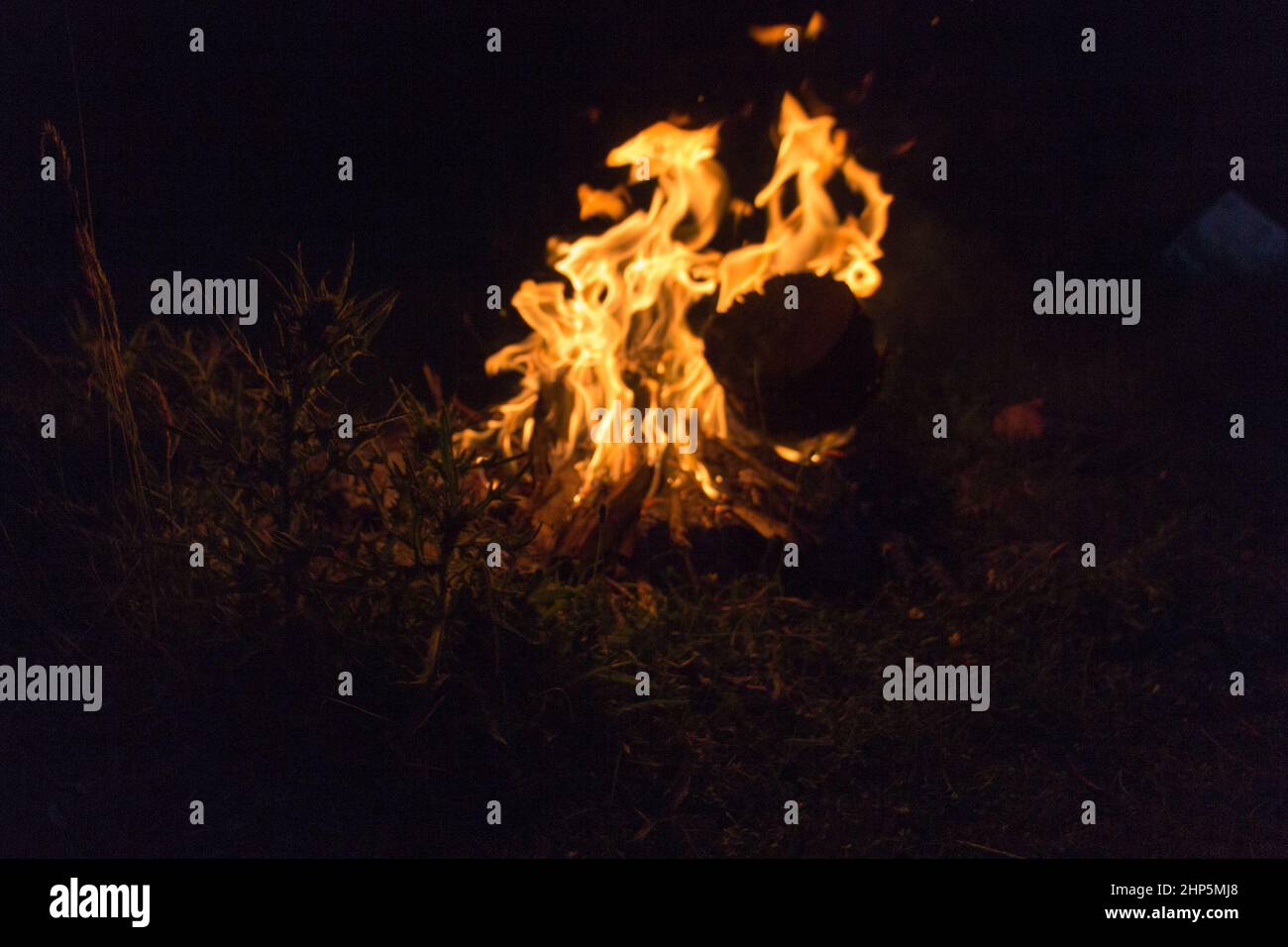 The view of bright flames and fire blazing at night on black background ...