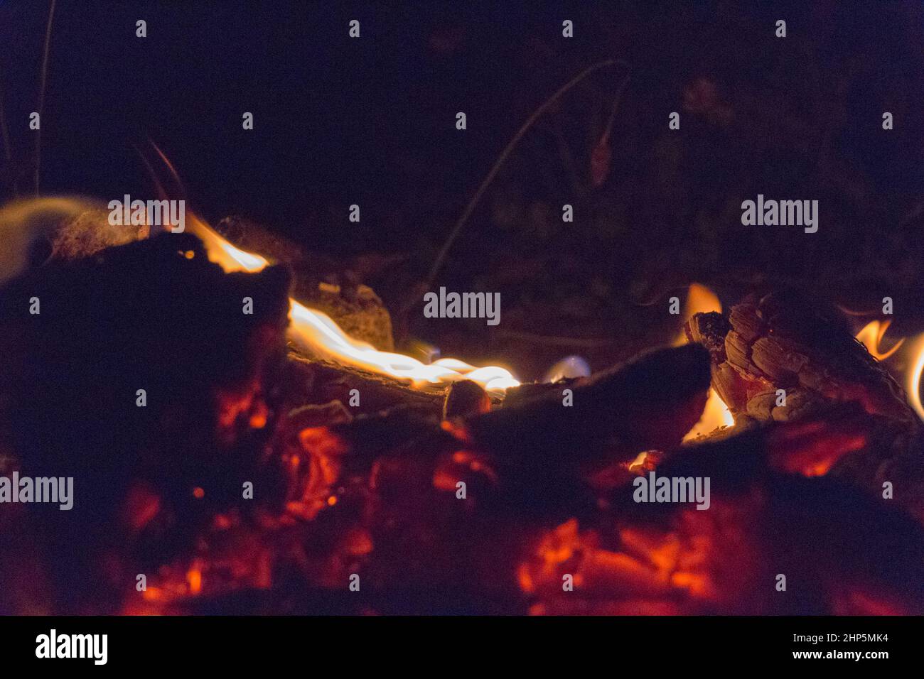 The view of a dying bonfire ready for snuffing on black background ...