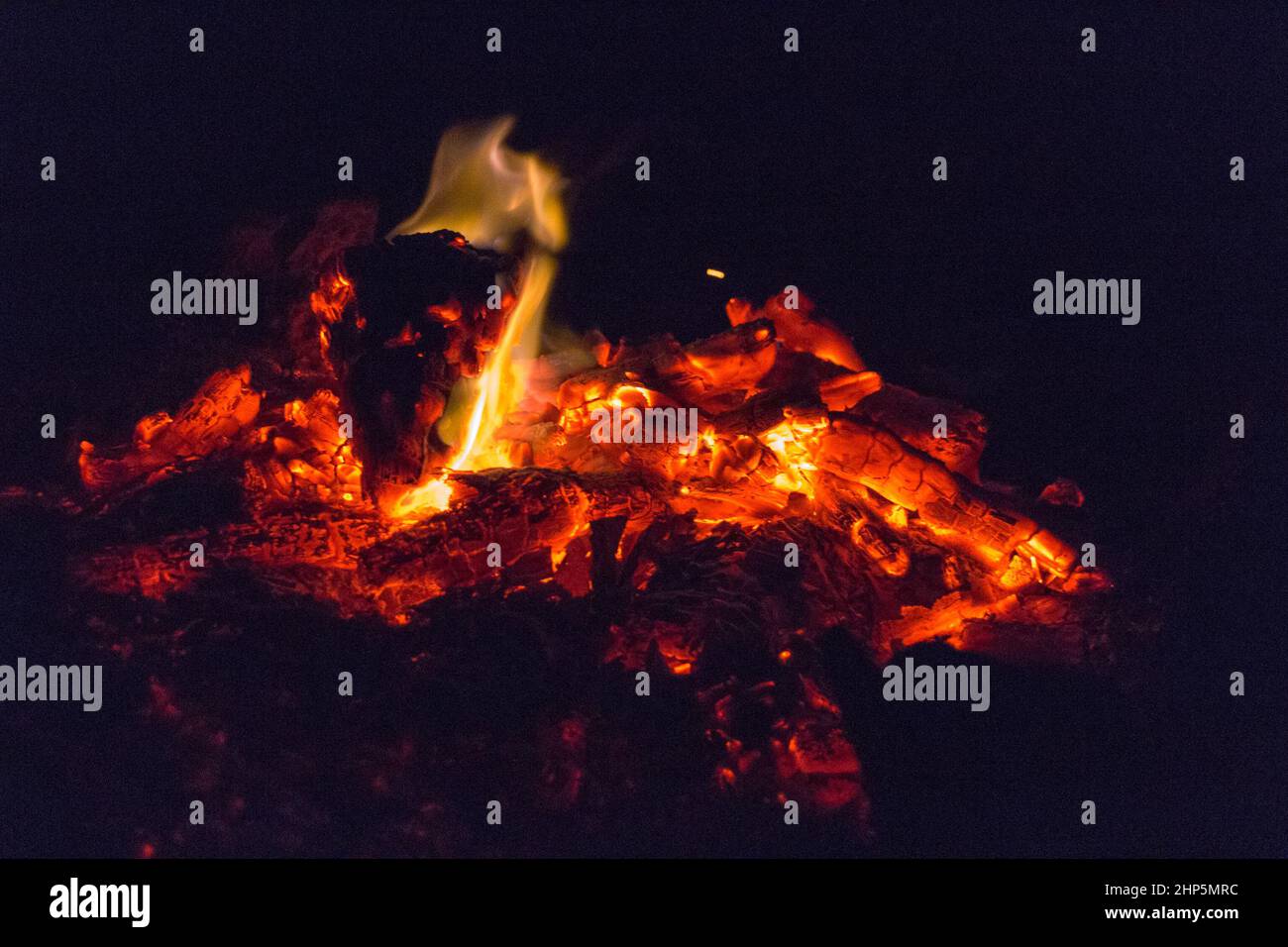 The view of a dying bonfire ready for snuffing on black background ...