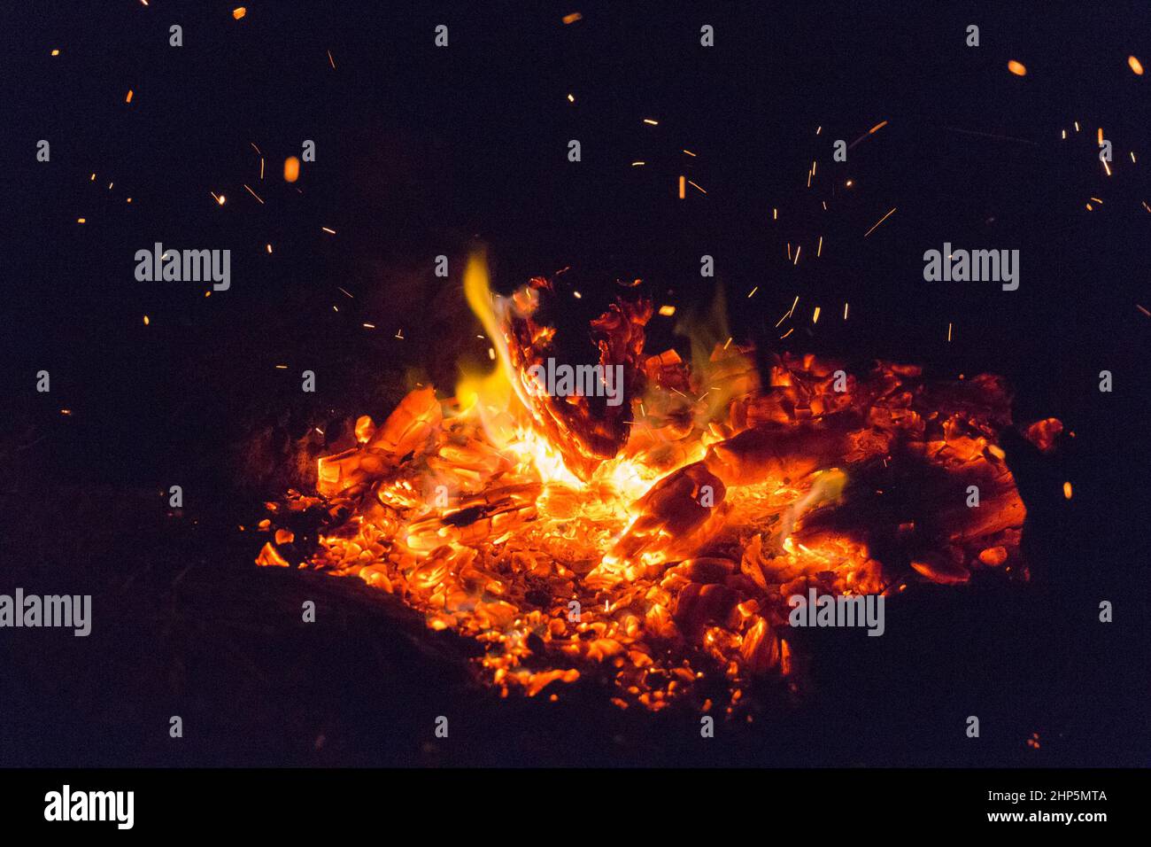 The view of a dying bonfire ready for snuffing on black background ...