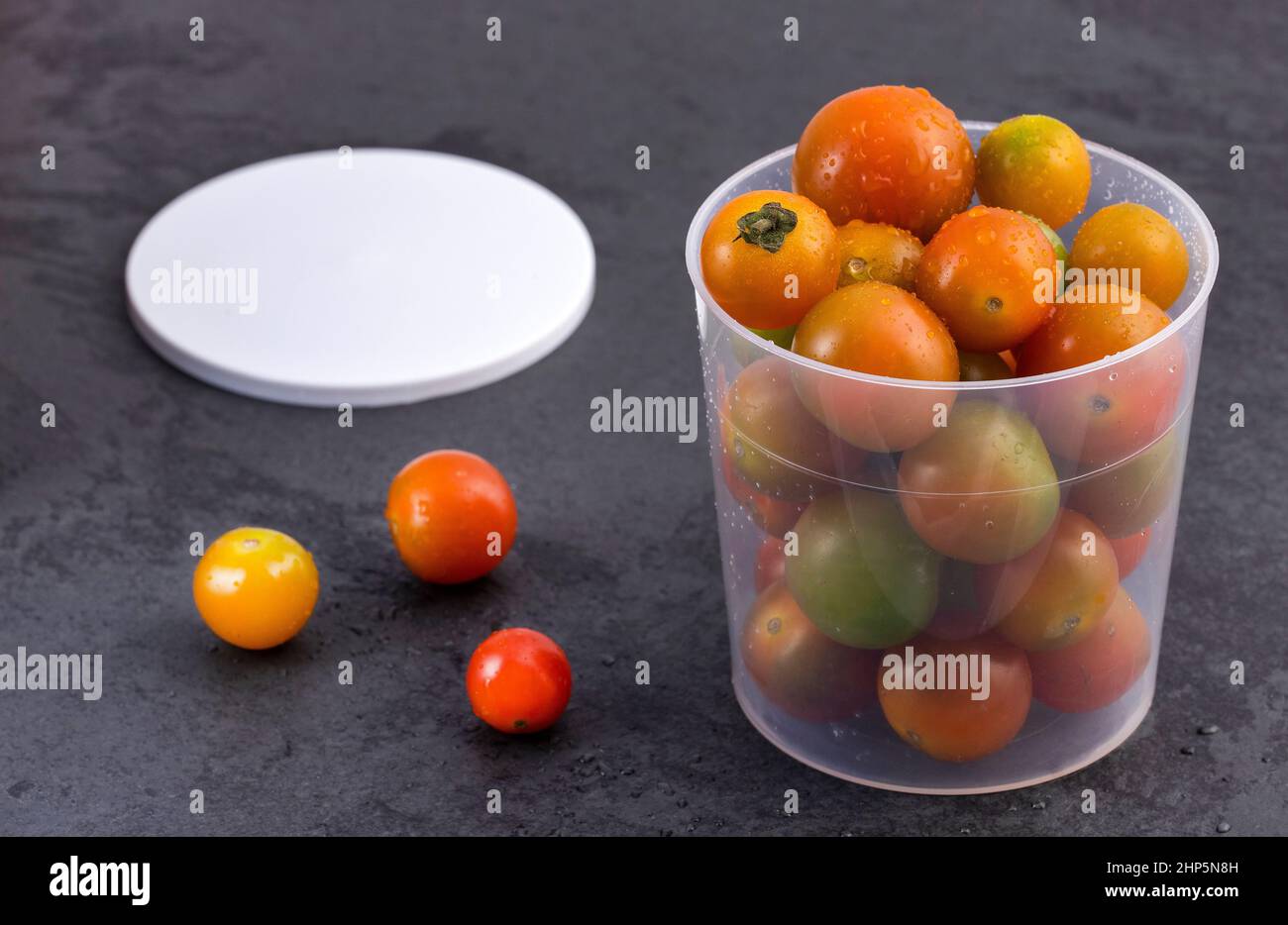Delicious cherry tomatoes in the container on the table Stock Photo - Alamy