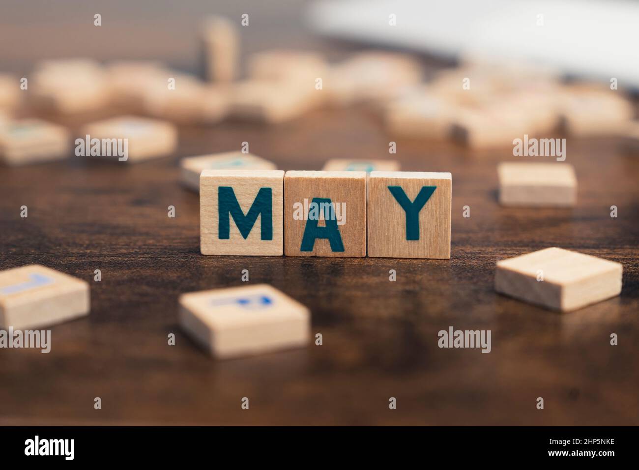 The name of the month May written on wooden cubes od the tabletop of th ...