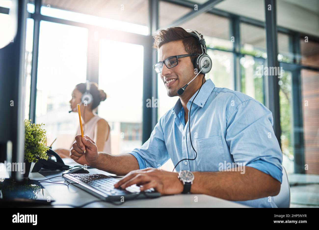 Man in office answers phone hi-res stock photography and images - Alamy