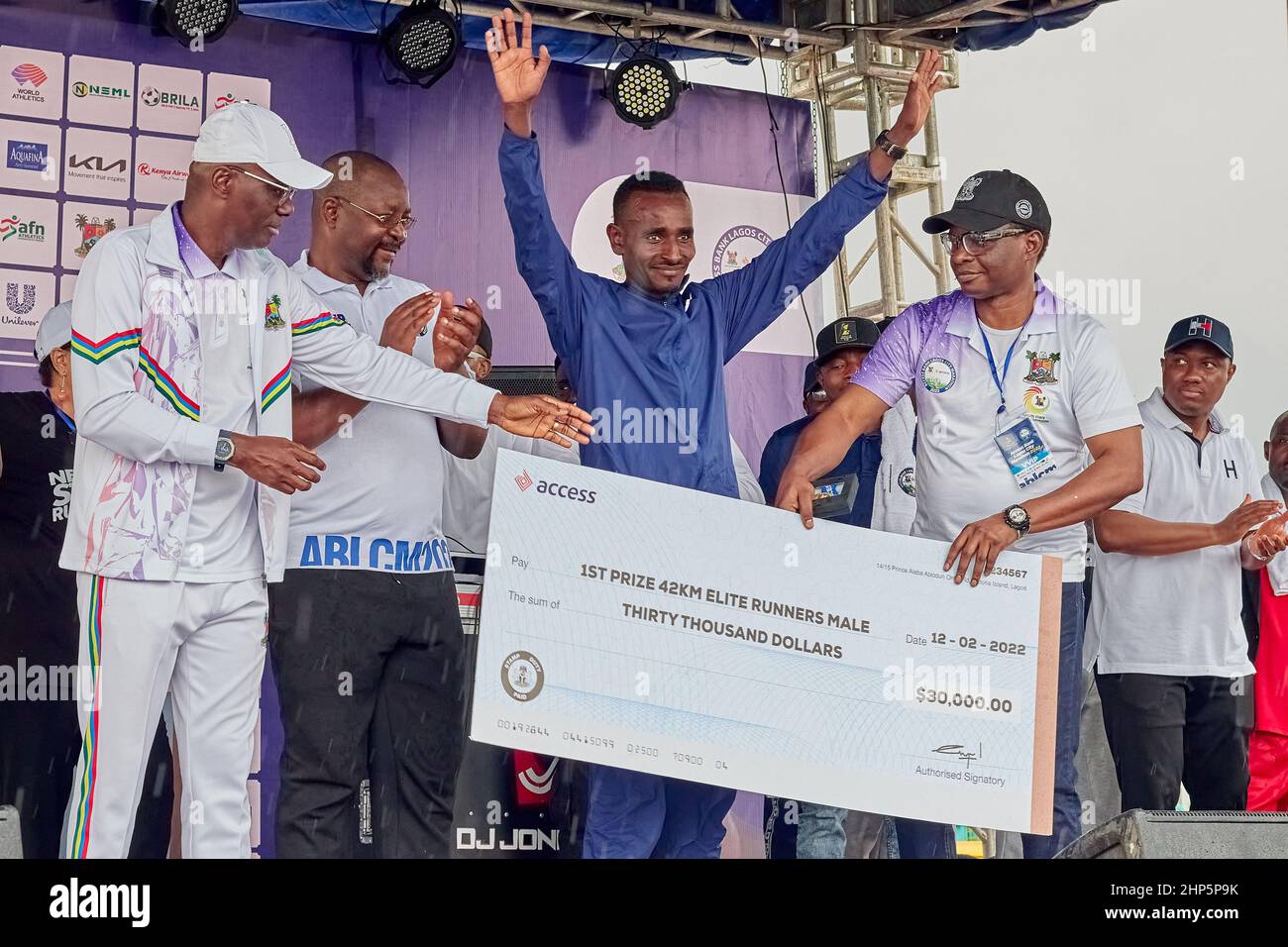 1st place marathon winner, Geleta Ulfata receives a medal and prize ...