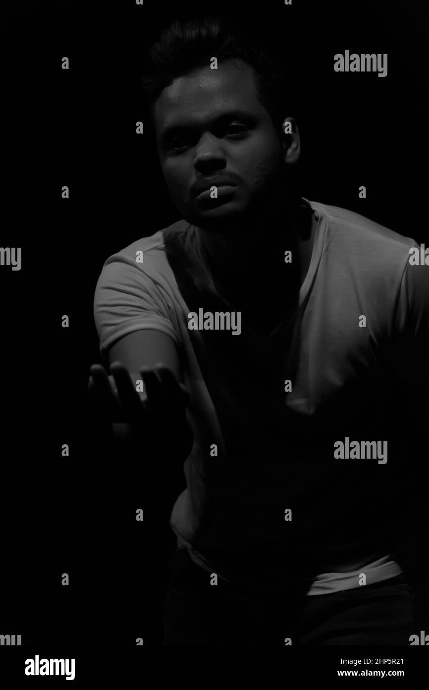 Standing actor representing a character in a theater. Black background ...