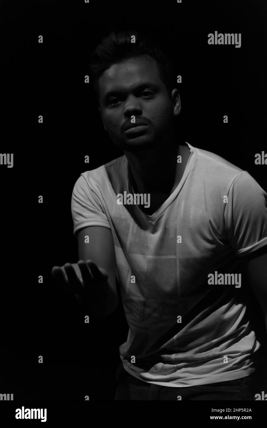 Standing actor representing a character in a theater. Black background ...