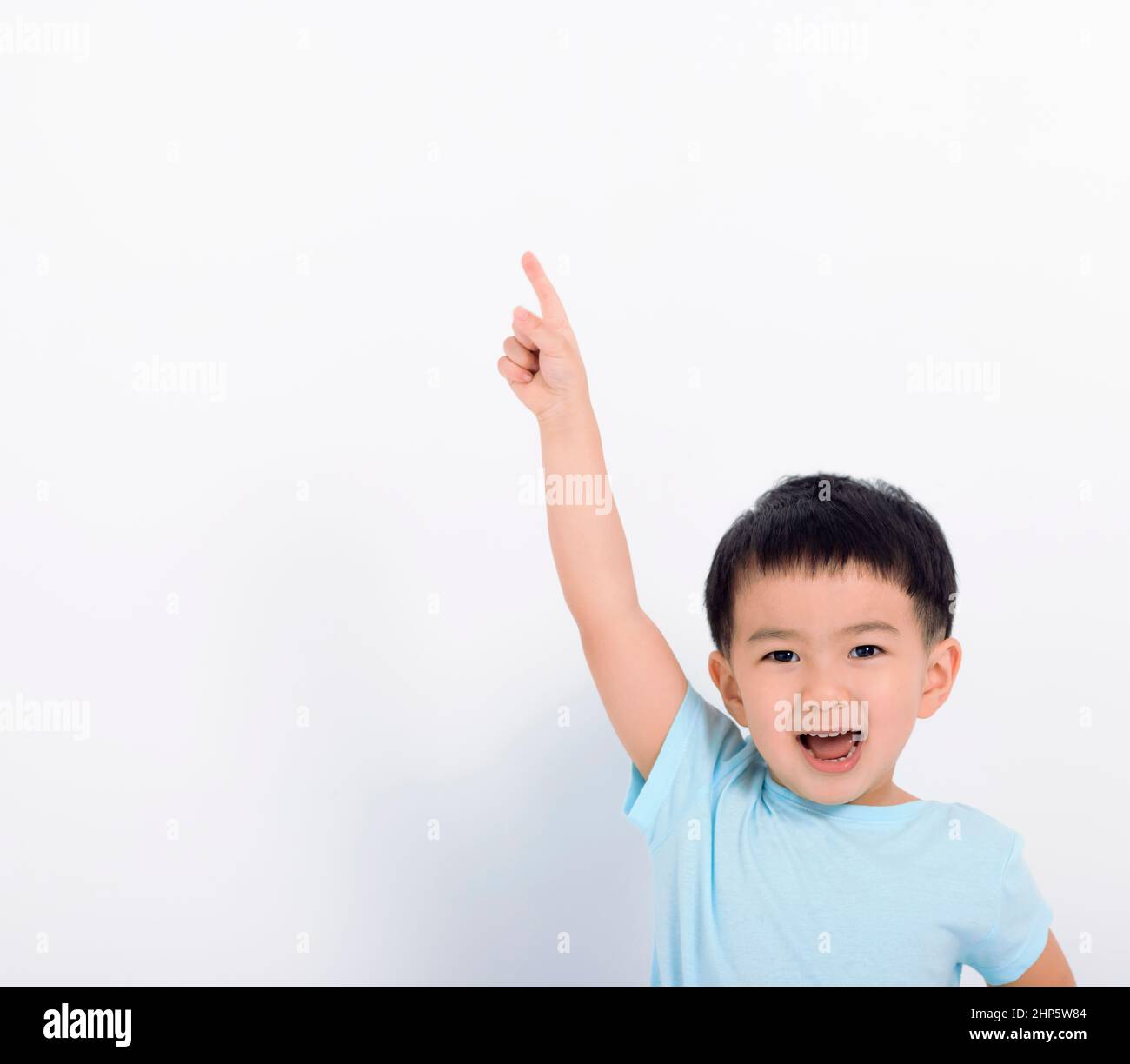 Happy little boy pointing to copy space Stock Photo - Alamy