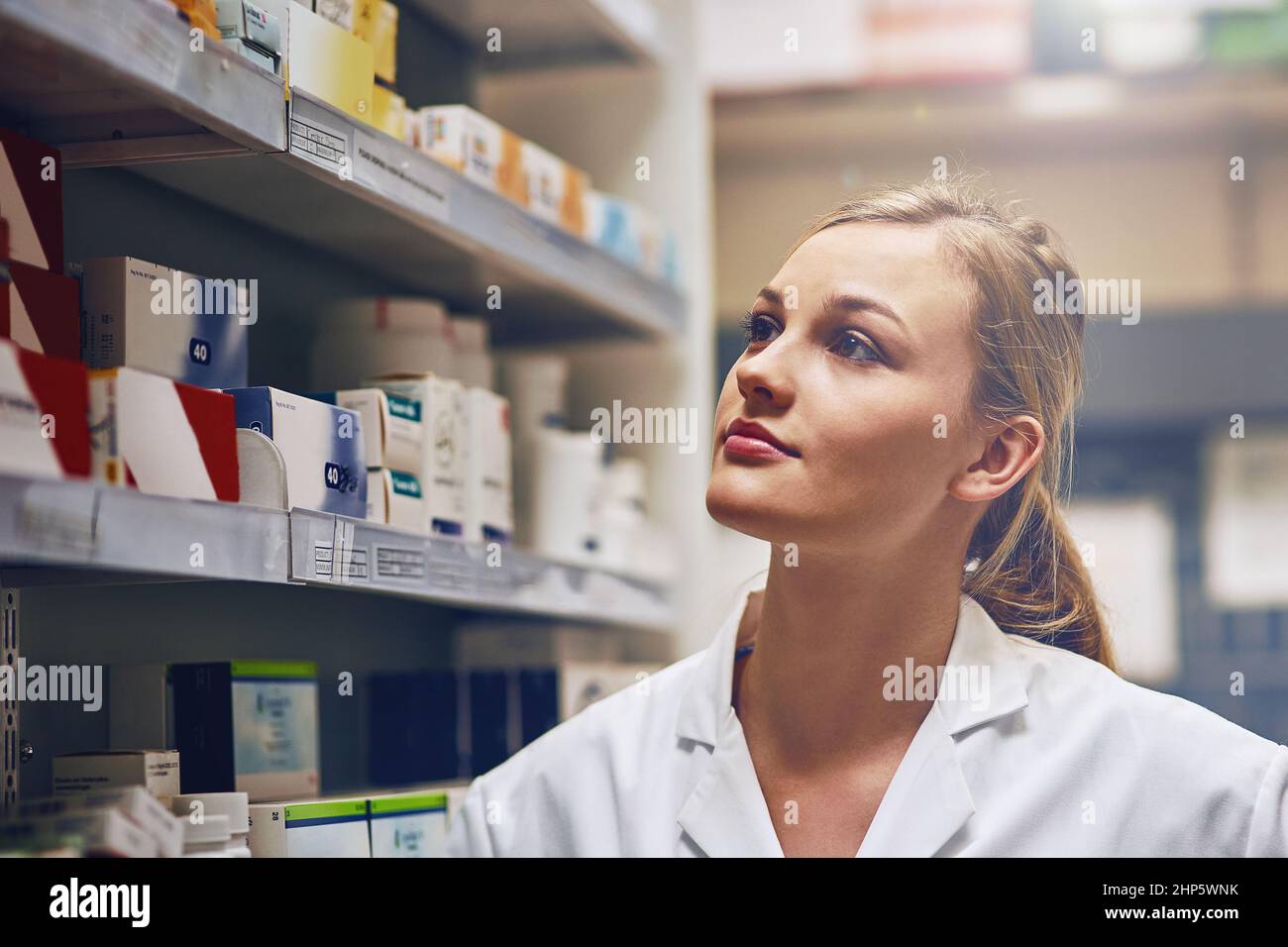 Positive young female pharmacist hi-res stock photography and images ...
