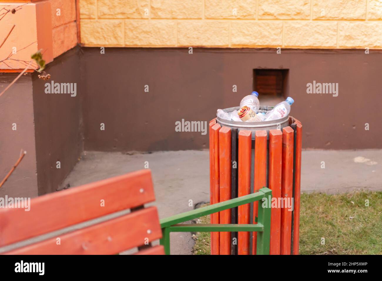 Garbage bins in the yard. An overflowing urn near the entrance of an ...