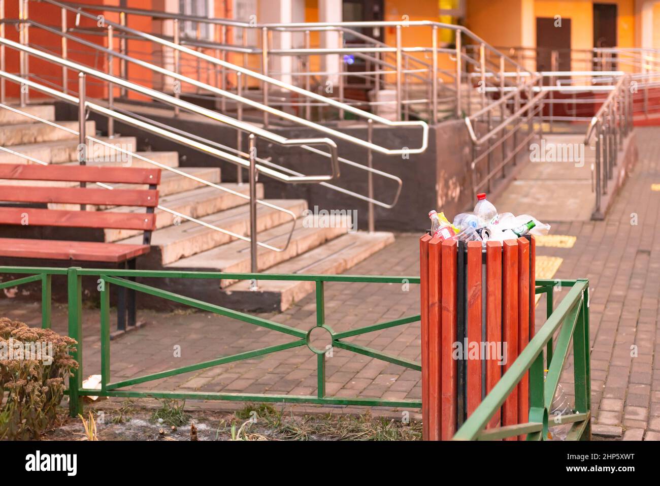 Garbage bins in the yard. An overflowing urn near the entrance of an ...
