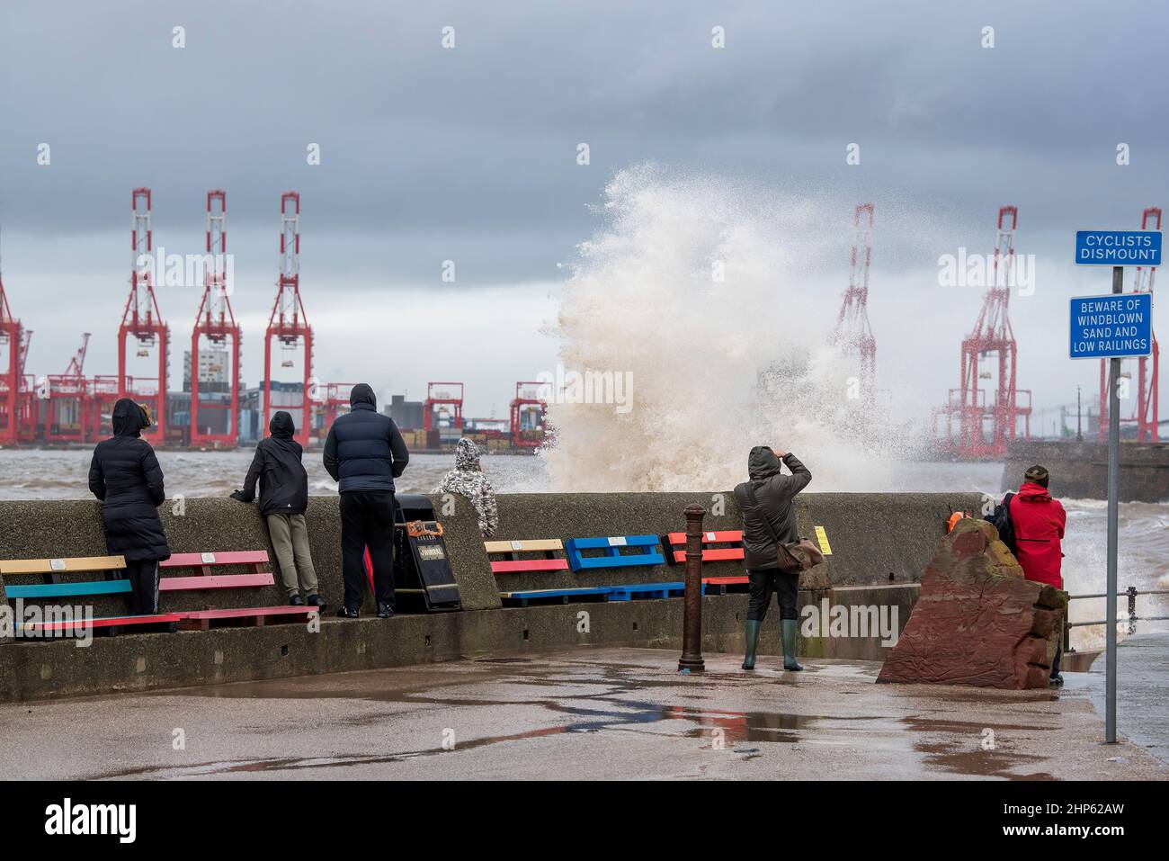 Liverpool, UK. 18th Feb, 2022. People view the waves created by high ...