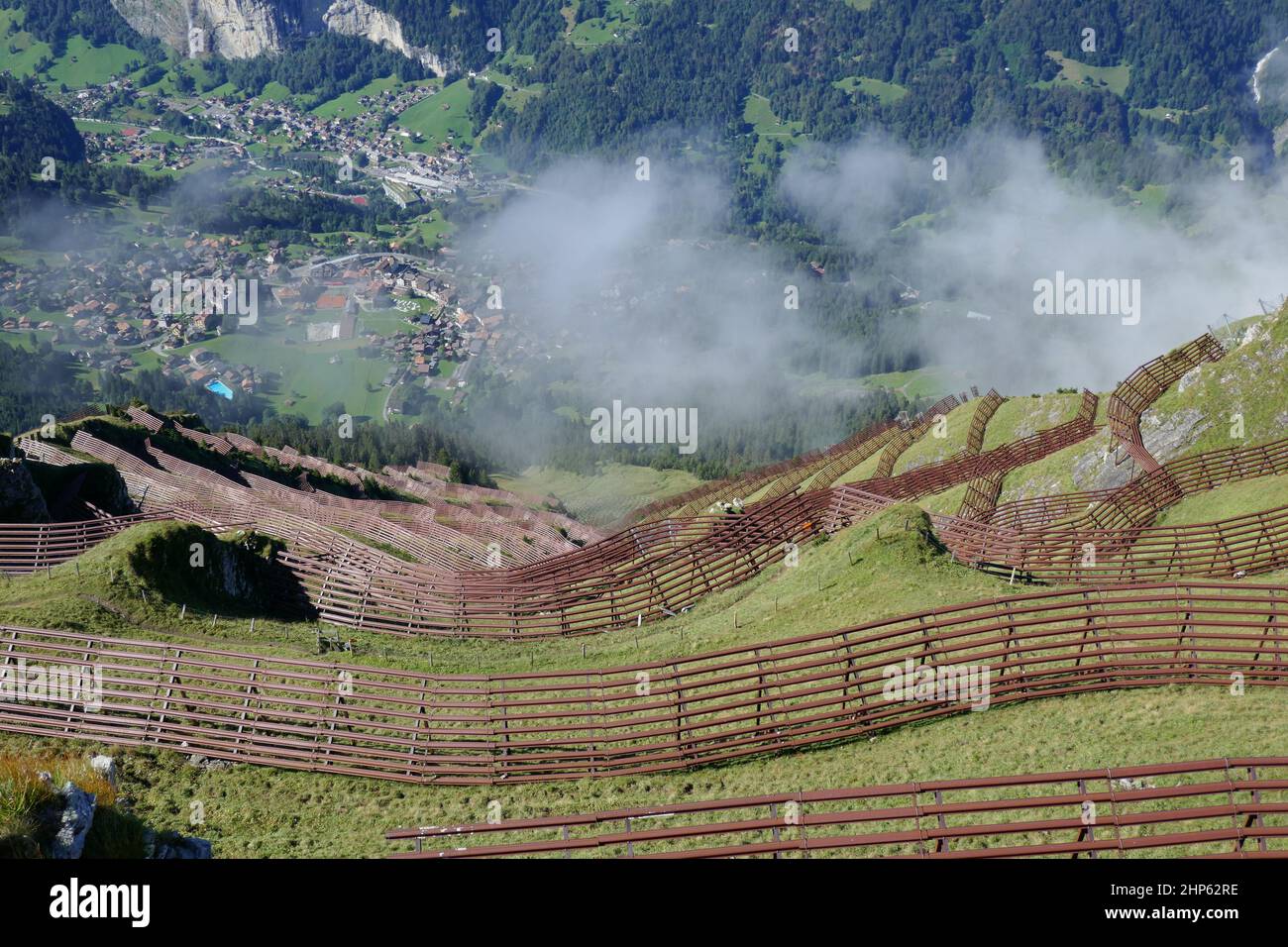 Snow fences on a mountainous landscape with a village in Wengen ...