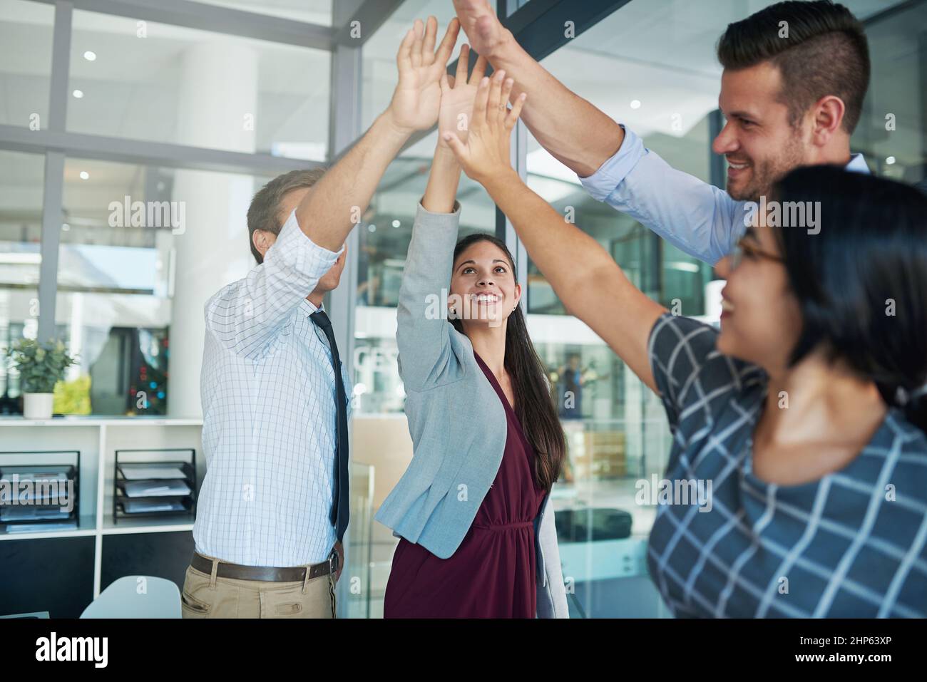 Big success requires big effort. Shot of a group of colleagues joining ...