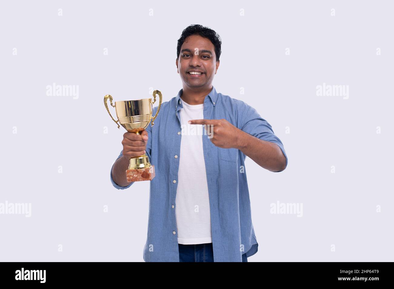 Young man holding a trophy hi-res stock photography and images - Alamy