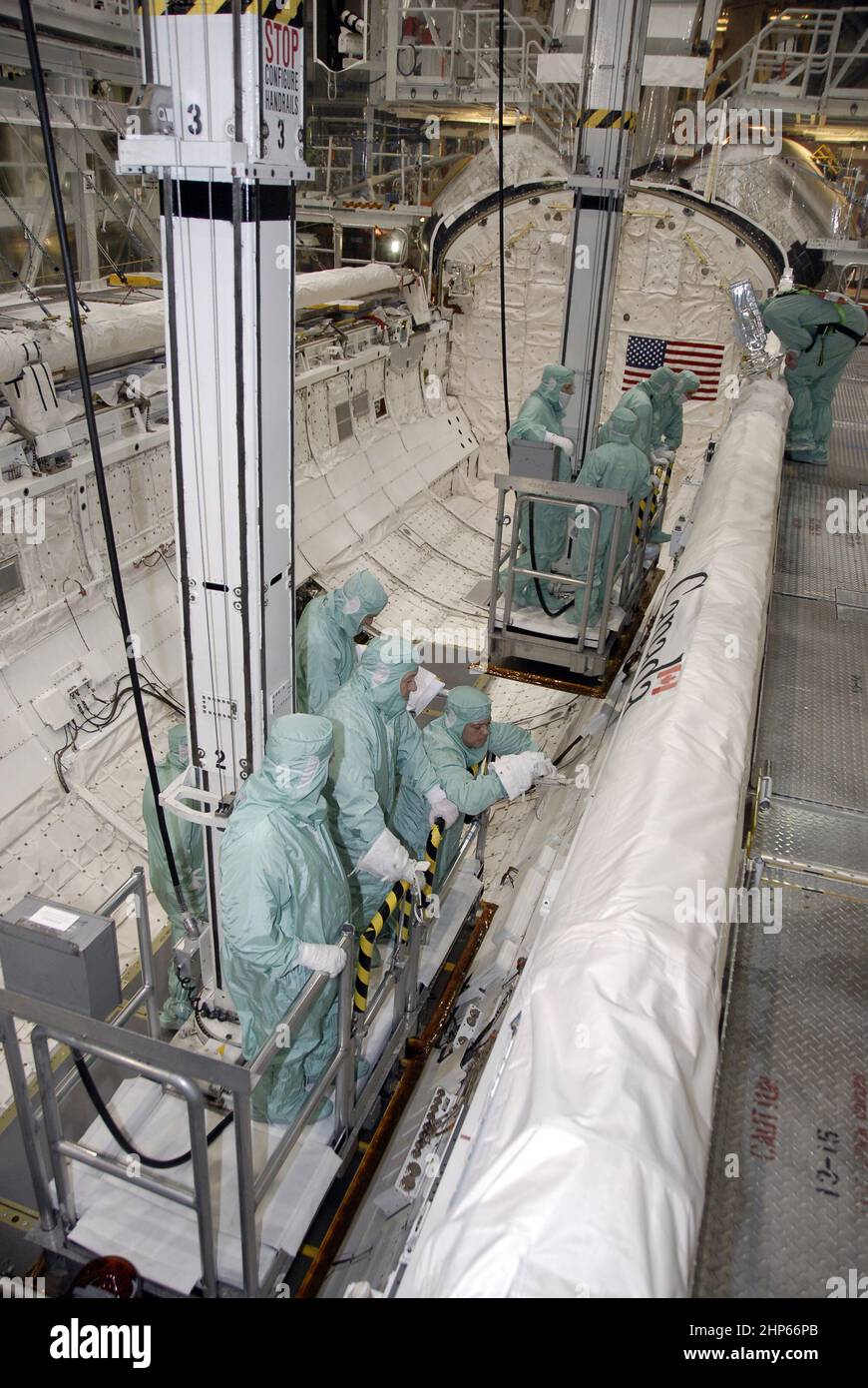 In Orbiter Processing Facility-3 at NASA's Kennedy Space Center in Florida, members of the STS ...