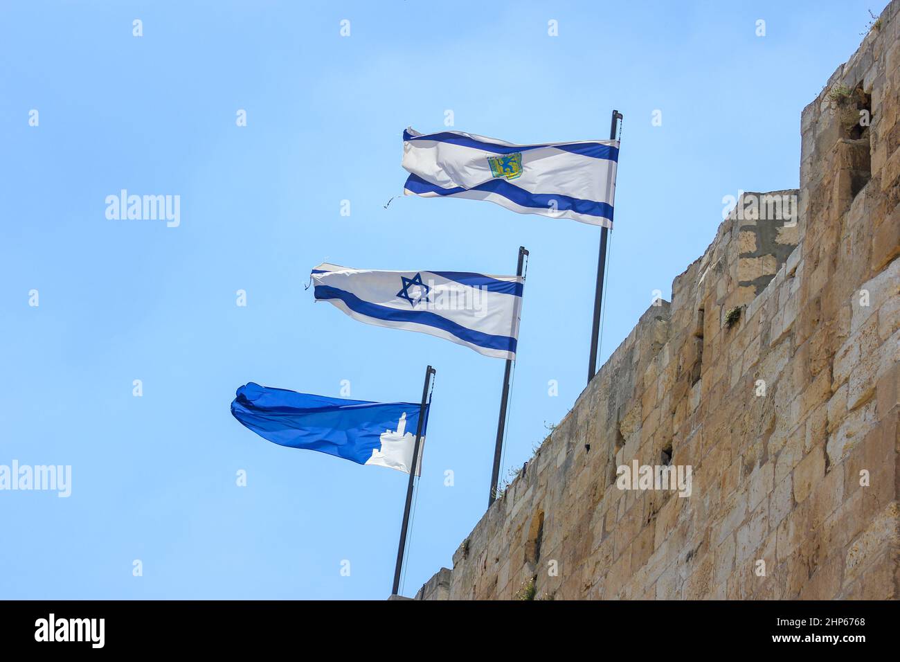 Modern flags flying over the old city walls in Jerusalem, Israel Stock ...