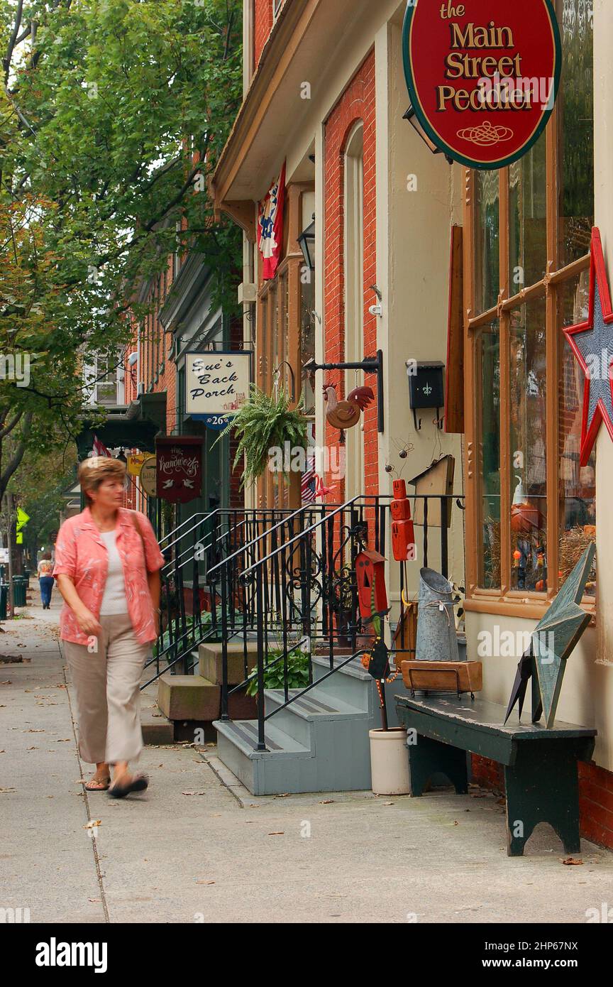 An adult woman shops in boutique stores in downtown Lititz ...