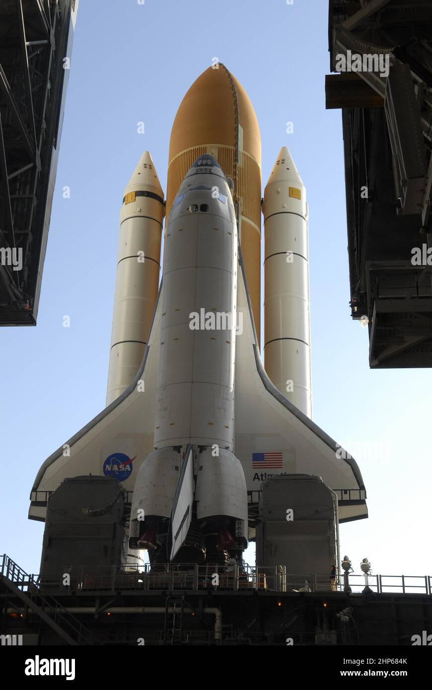 On a slow roll, Space Shuttle Atlantis moves through the open door of ...