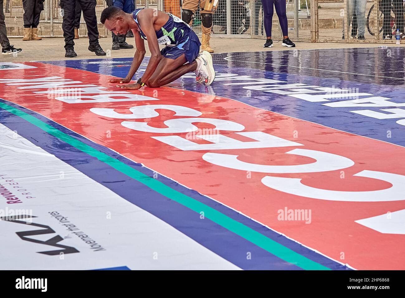 Marathon winner, Geleta Ulfata rests after crossing the finish line in ...