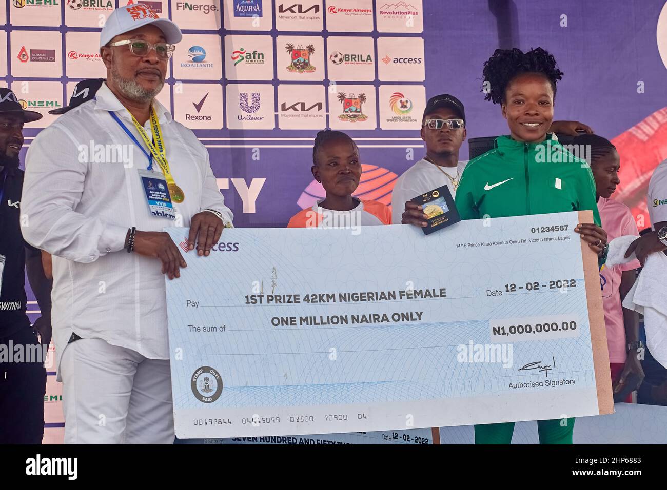 Female marathon winner receives prize money after competing in the ...