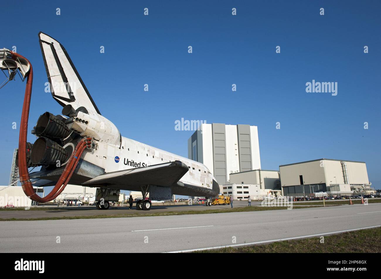 Space shuttle Discovery, pulled by its "towback" vehicle, approaches ...