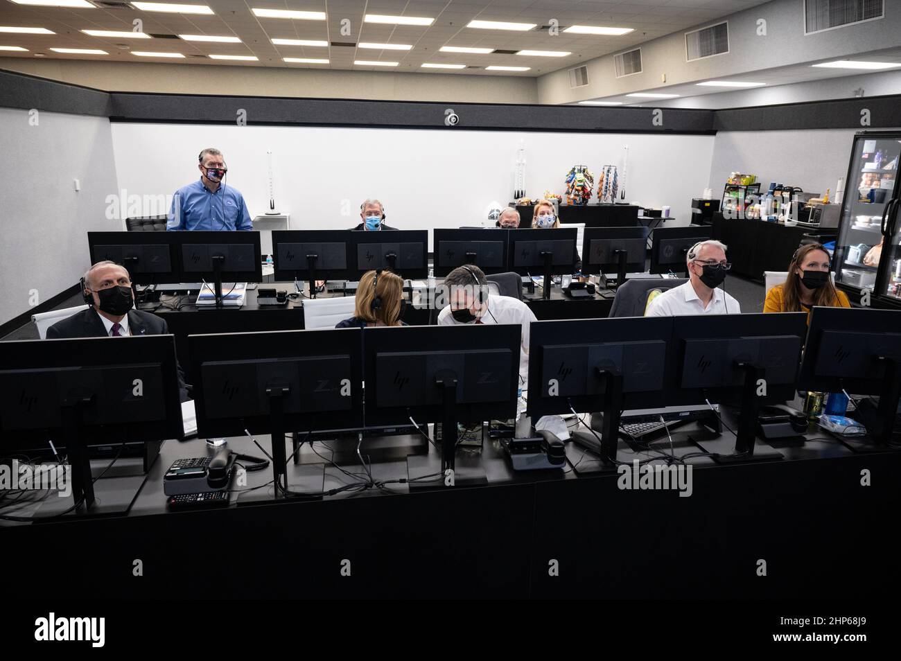 NASA and SpaceX managers are seen as they monitor the countdown of the ...