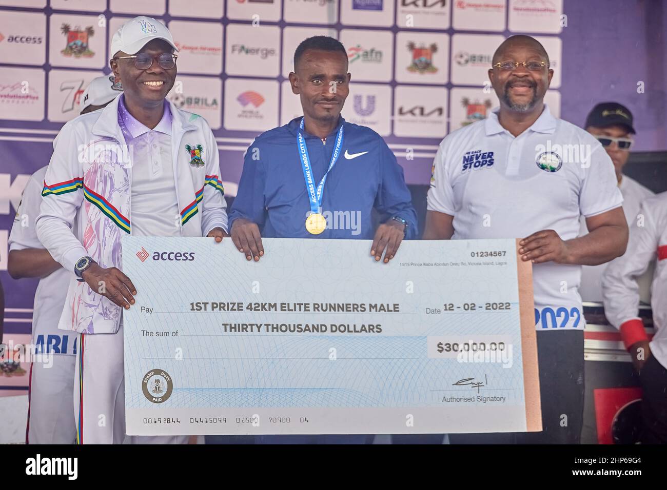 1st place marathon winner, Geleta Ulfata receives a medal and prize ...