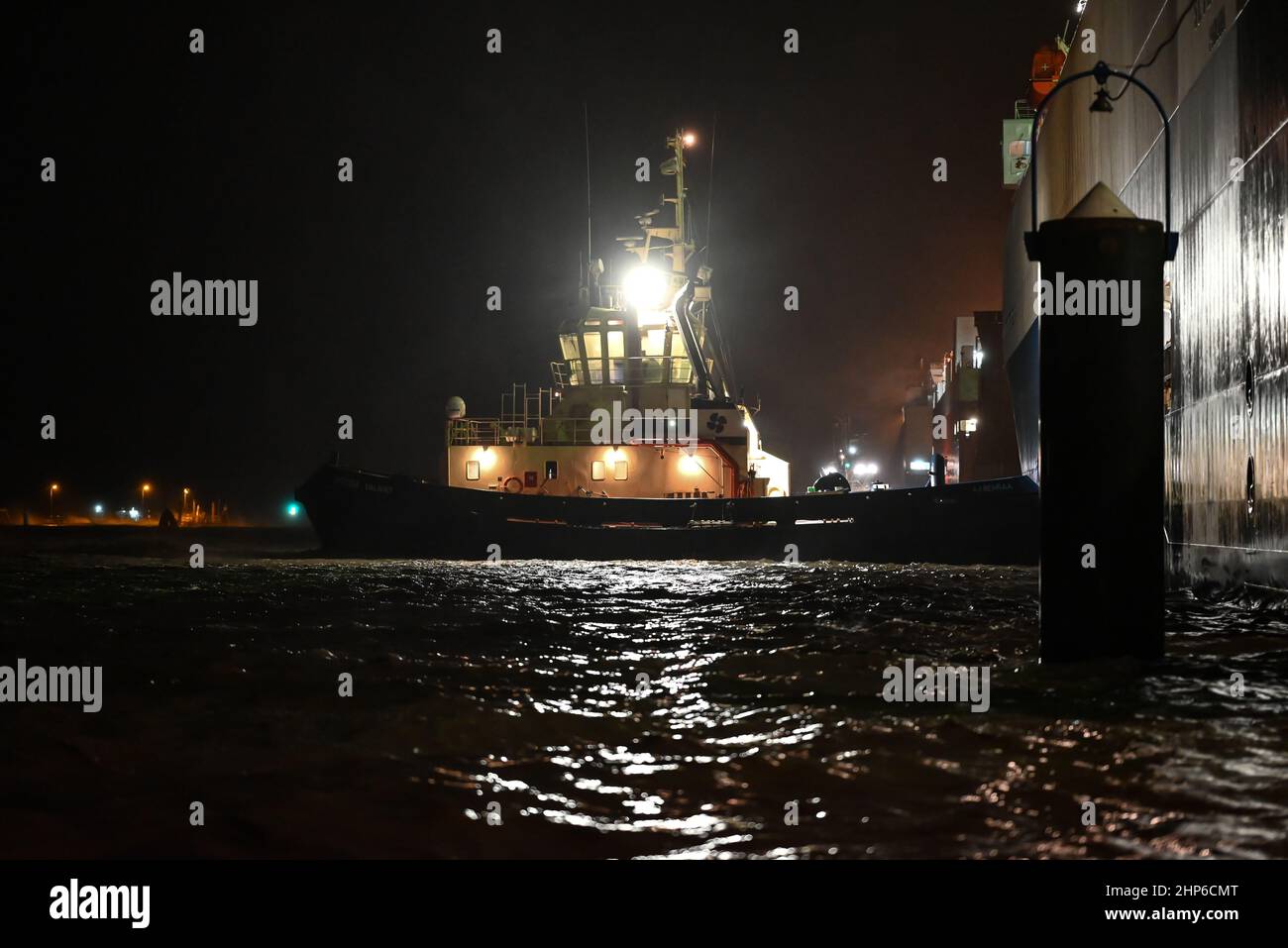 Emden, Germany. 19th Feb, 2022. The tug "Svitzer Valand" pushes a large ...
