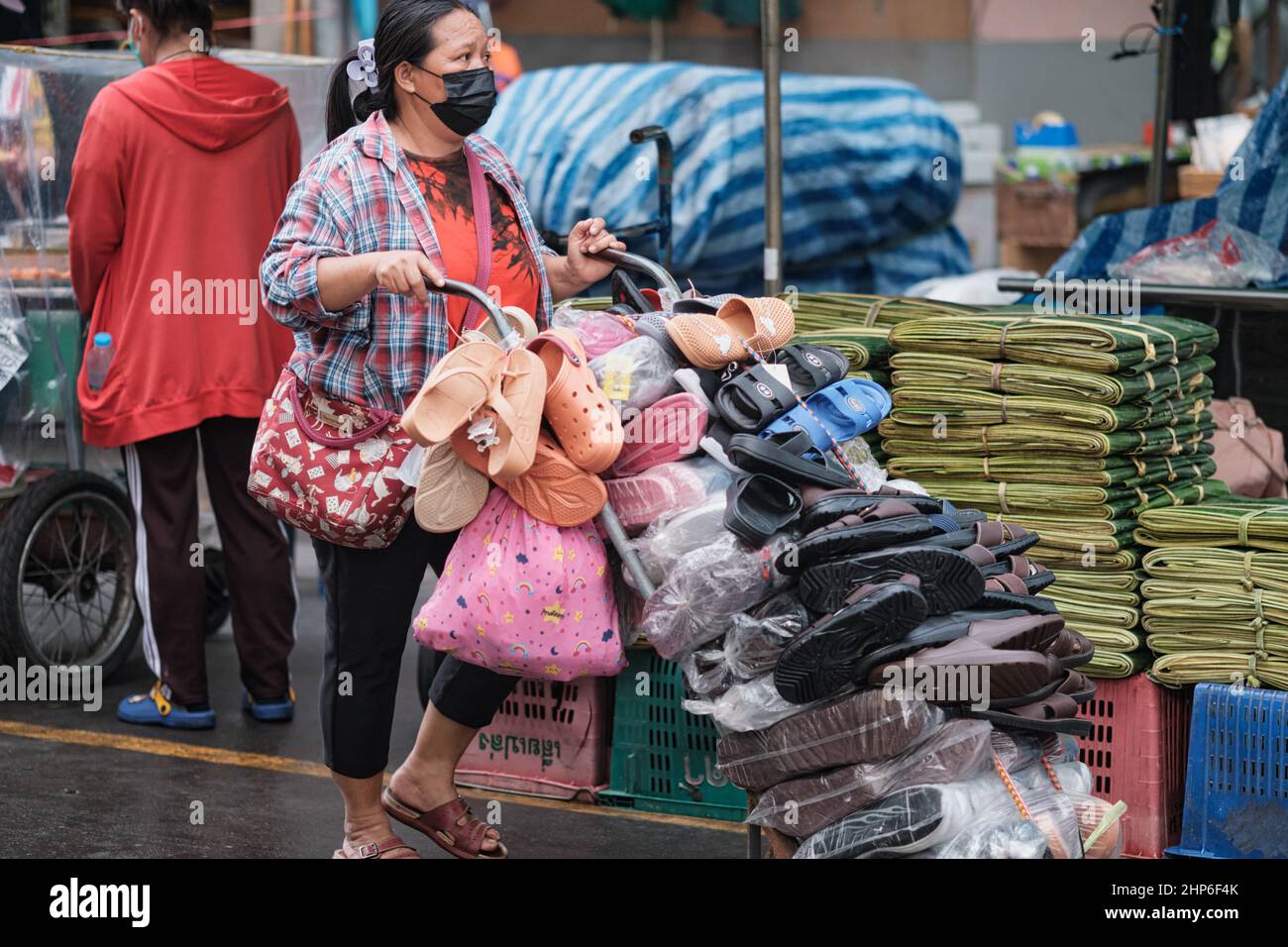 An itinerant vendor in Pak Klong Talat (market) in Bangkok, pushing her ...