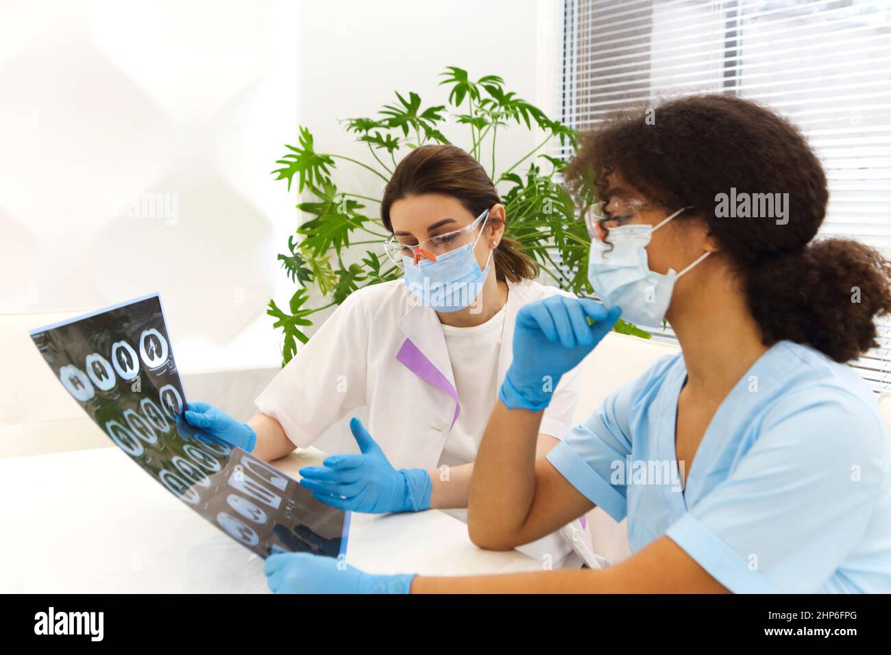 Focused worried multiethnic healthcare workers analyzing CT lung ...