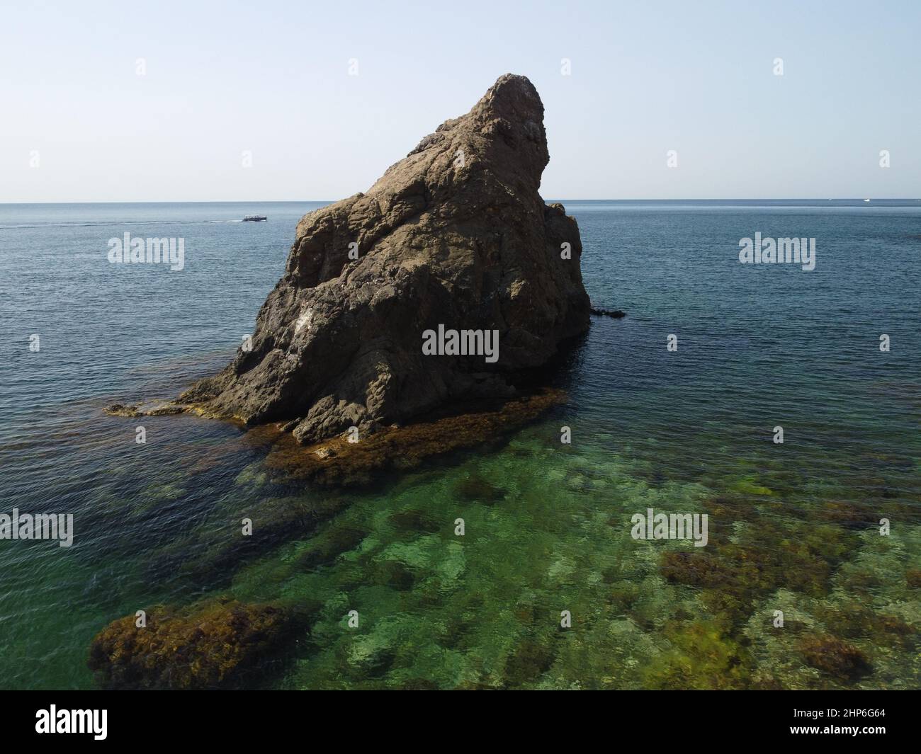 Aerial view from above on calm azure sea and volcanic rocky shores ...