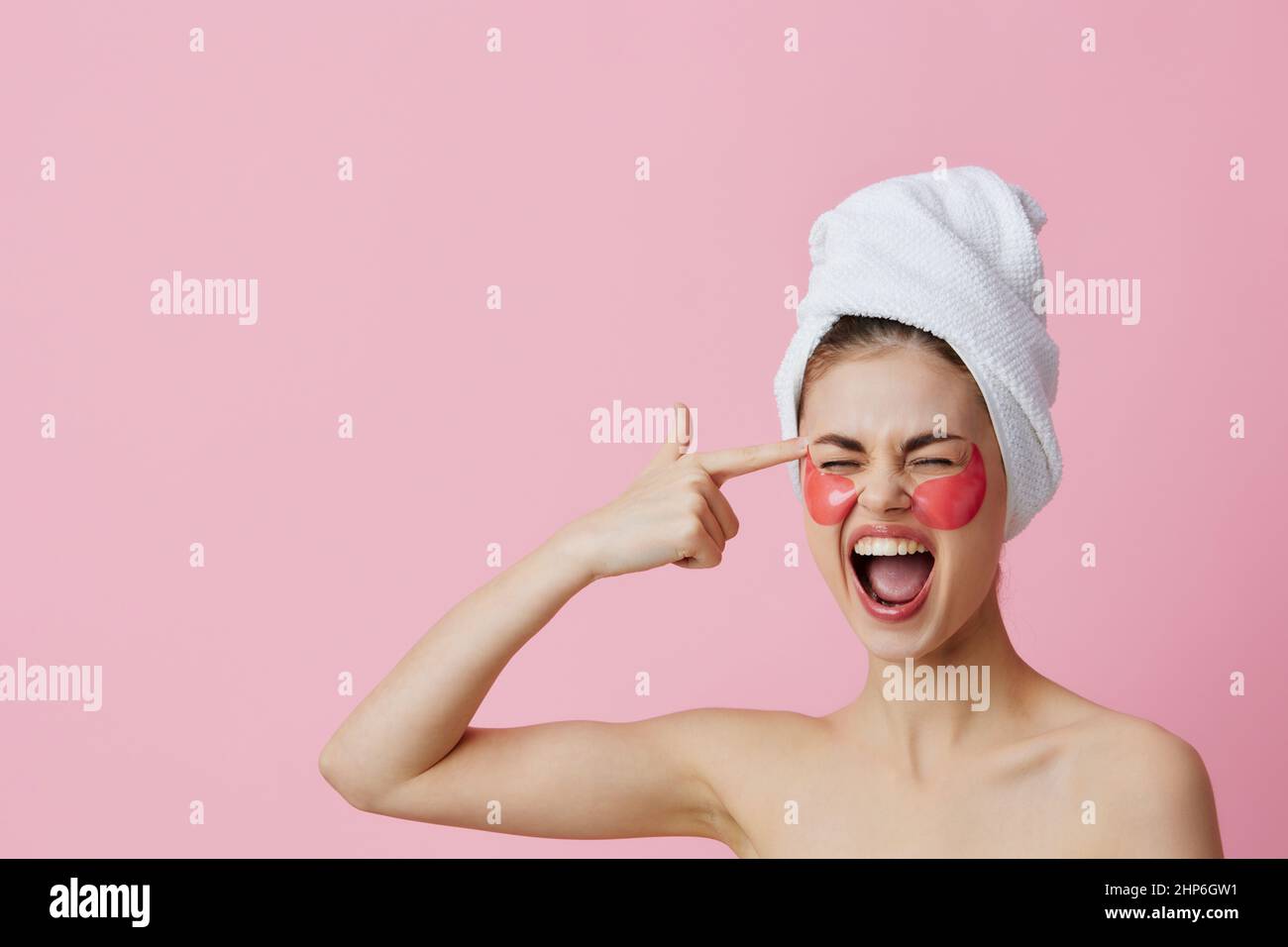 portrait woman pink patches on the face with a towel on the head pink ...