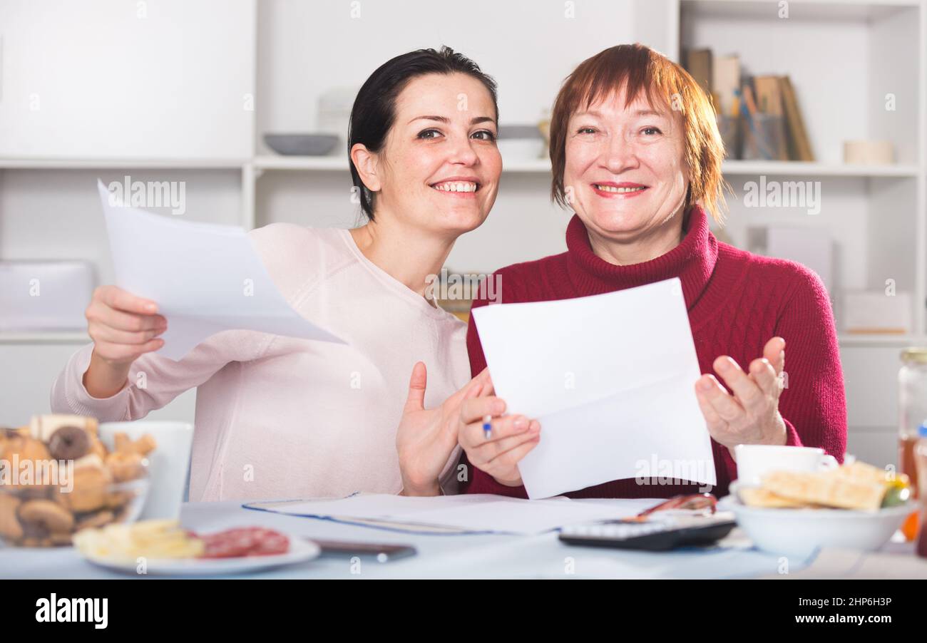 Portrait of family looking at documents hi-res stock photography and ...