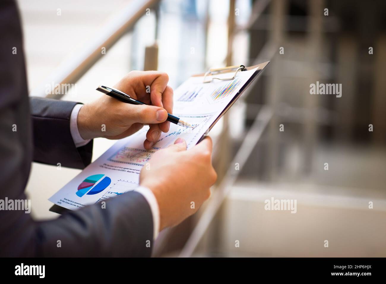 Close-up of female and male hands pointing at business document while ...
