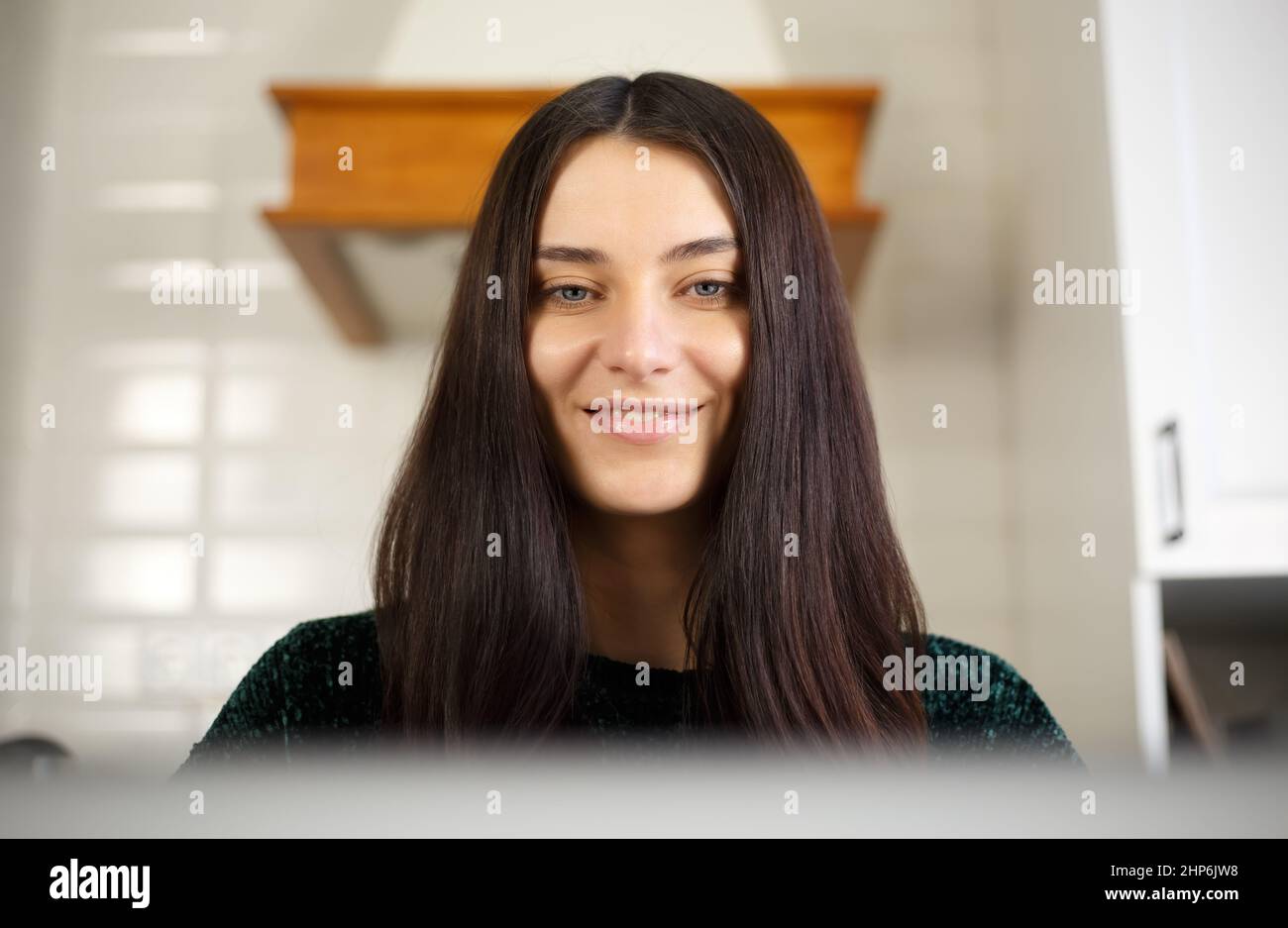 Happy white woman reading from computer screen. Beautiful young female ...