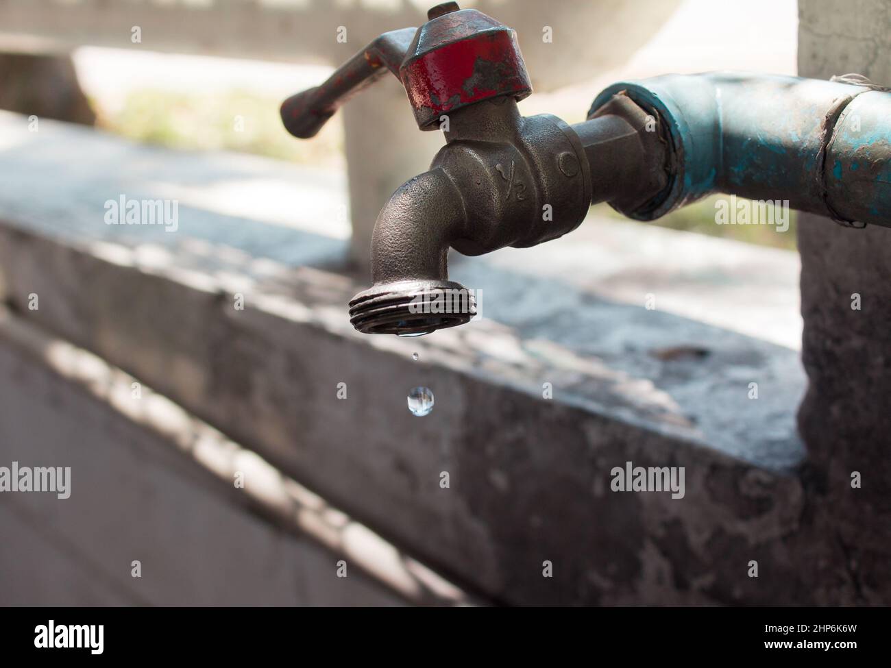 old faucet on concrete wall, save the water concept Stock Photo - Alamy